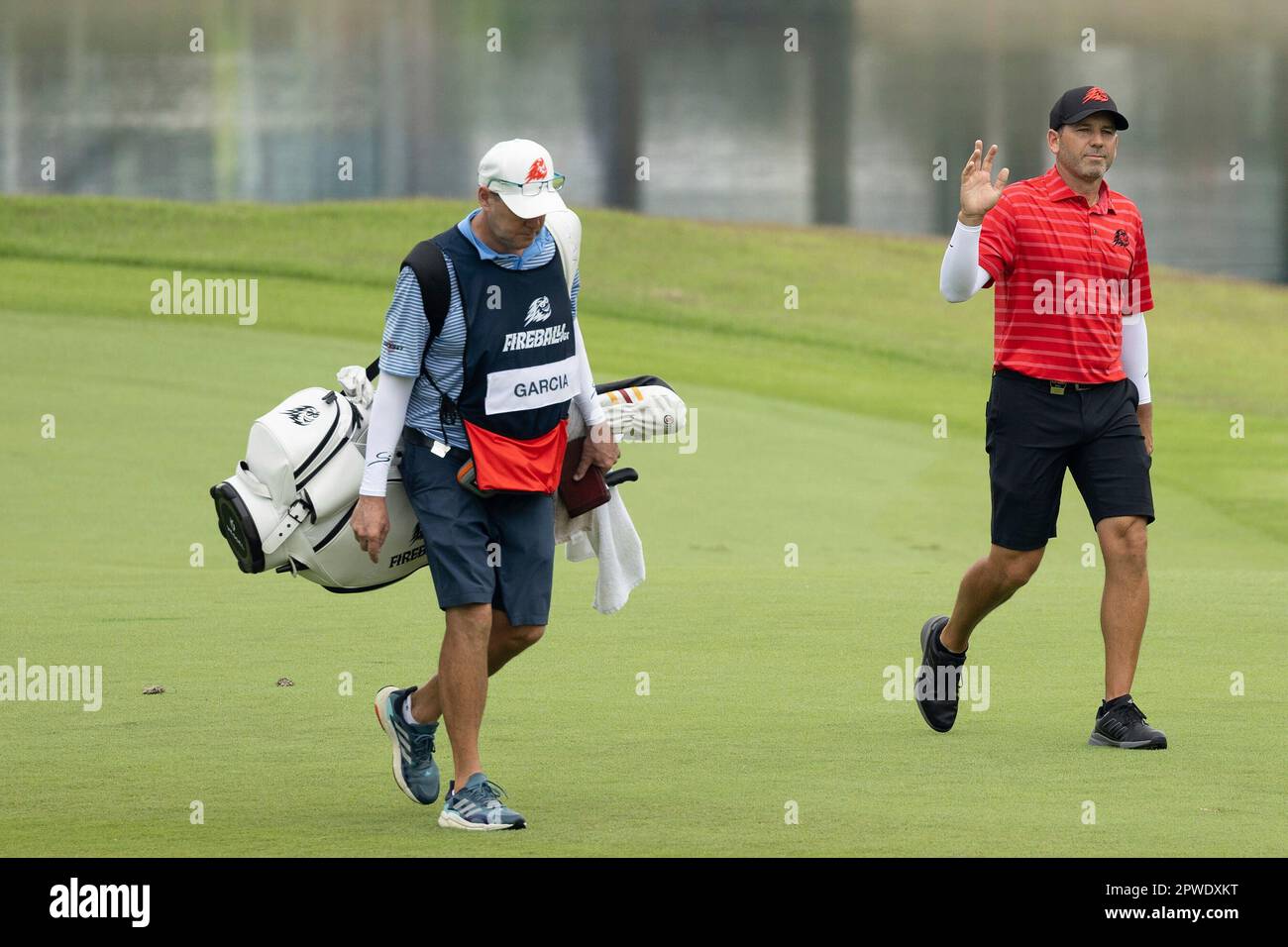 Captain Sergio Garcia of Fireballs GC waves as he walks up the 18th ...