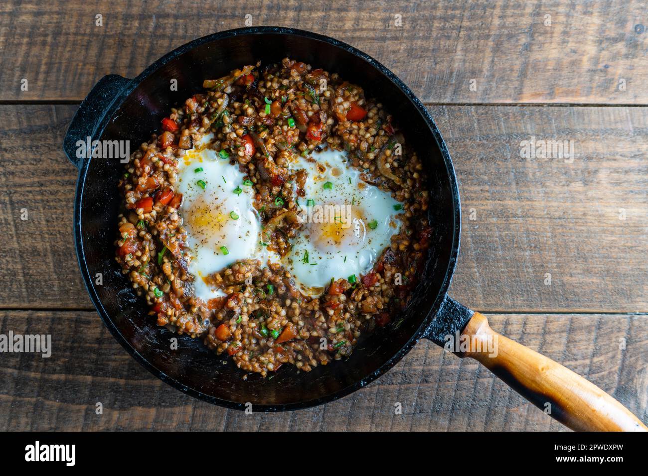 Boiled buckwheat with fried eggs, red peppers, carrots and onions ...