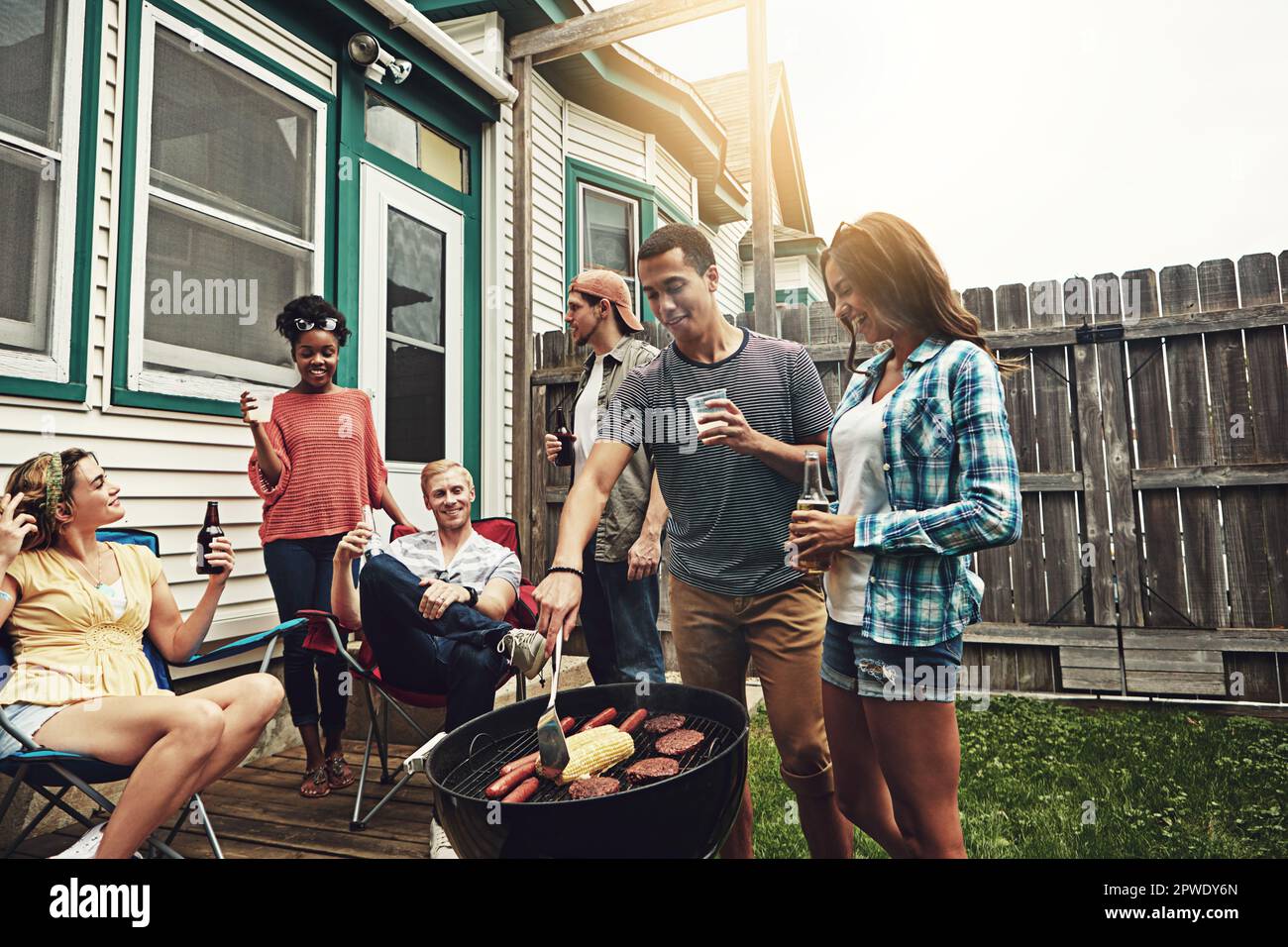 Its a backyard bbq and everyones invited. a group of friends having a ...