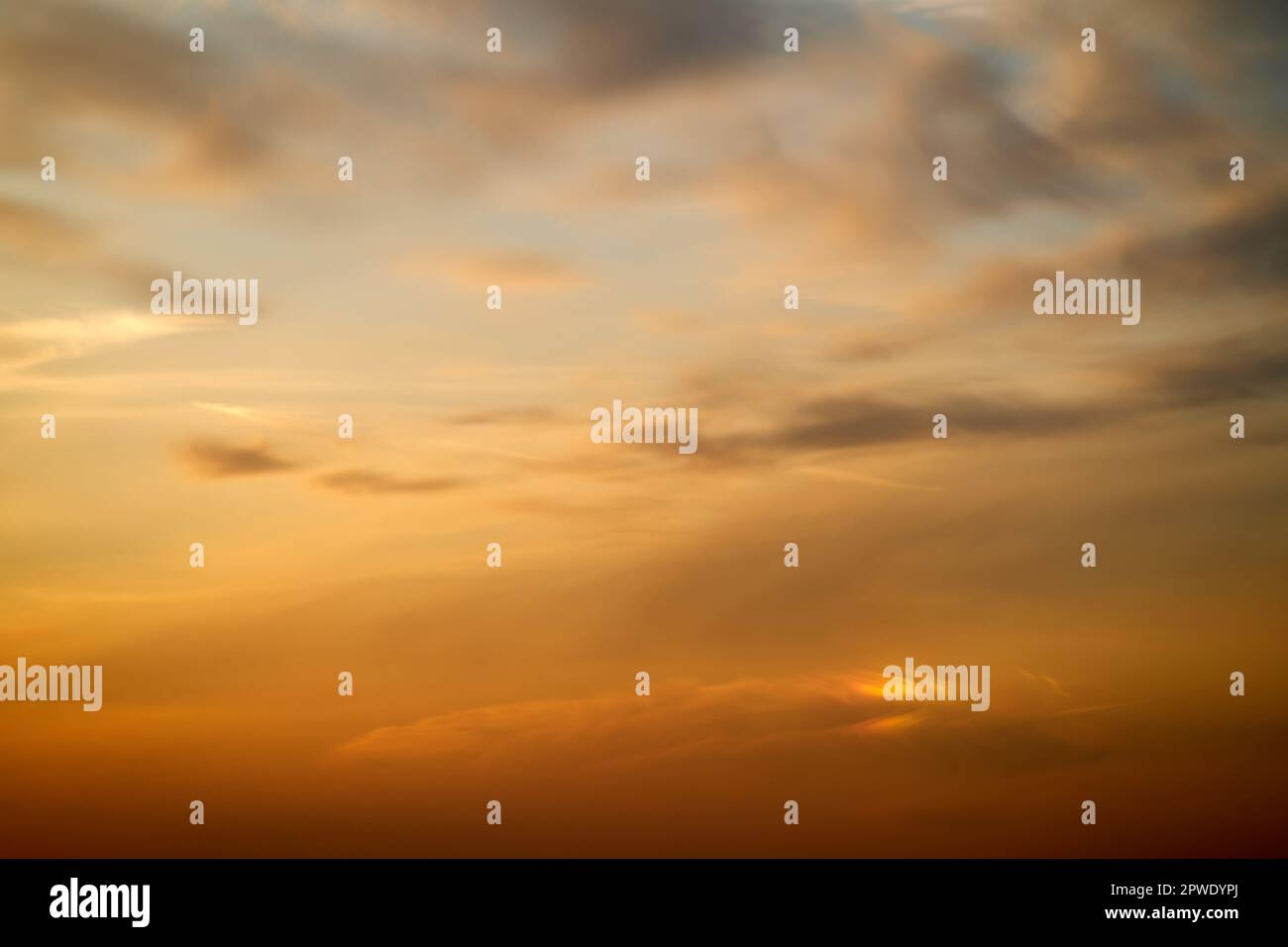 Sunset sky with red light of the setting sun. Evening clouds in the ...