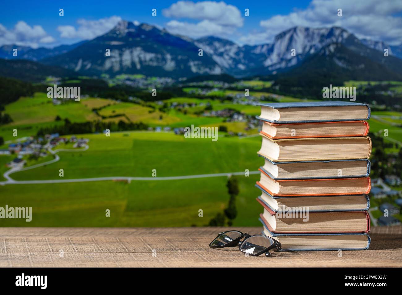 Book stack in the library room and blurred bookshelf for business and ...