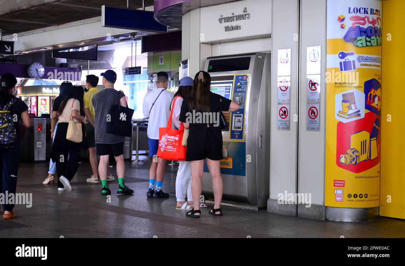 People buy tickets to travel on the Skytrain at Sala Daeng station in ...