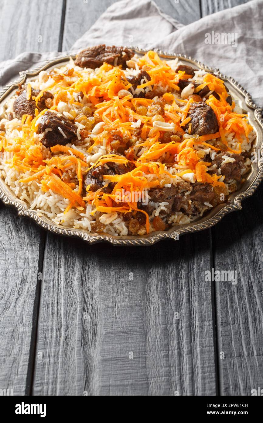 Traditional Kabuli Pulao with Sweet Carrot and raisins topping closeup ...