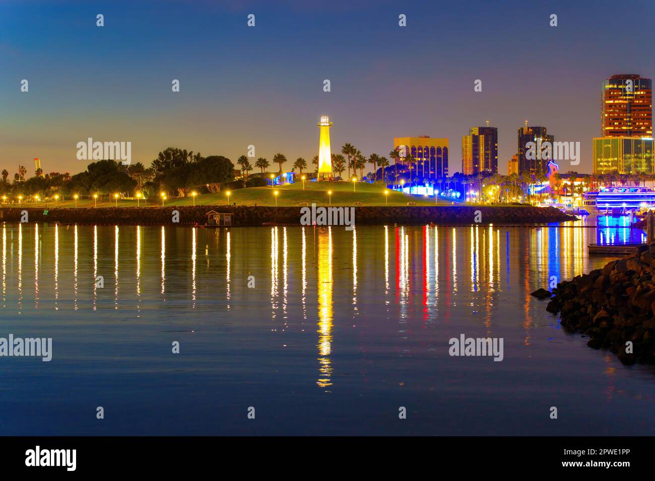 Lions Lighthouse in Long Beach, California glows in the night, casting ...