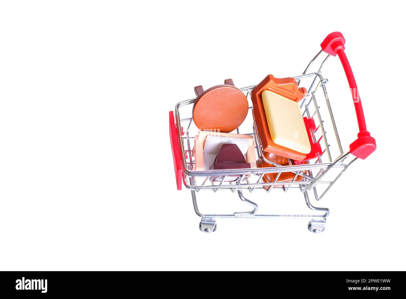 Miniature shopping trolley overflowing with an assortment of tiny toy ...