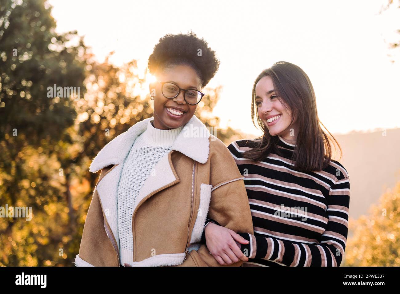 two young friends smiling happy in nature Stock Photo - Alamy