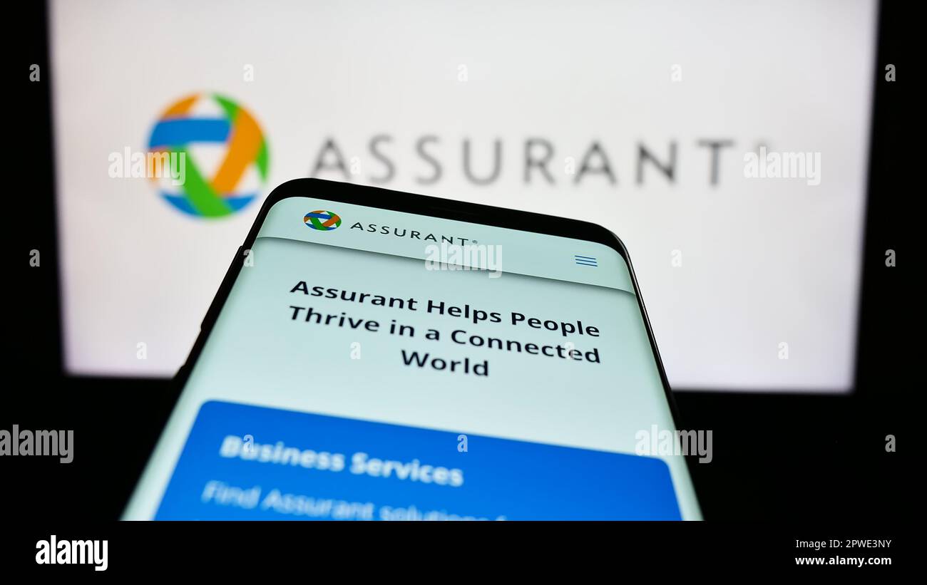 Smartphone with website of US insurance company Assurant Inc. on screen ...