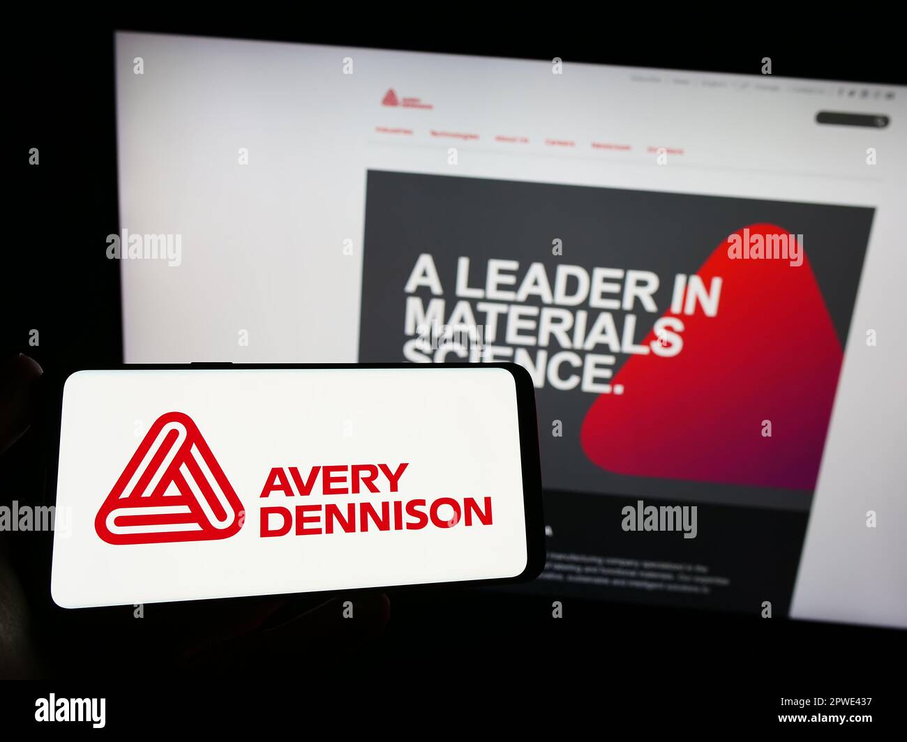 Person holding smartphone with logo of US packaging company Avery ...