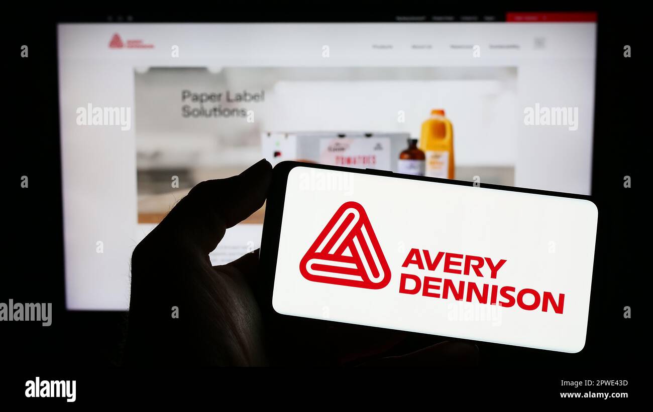 Person holding mobile phone with logo of US packaging company Avery ...