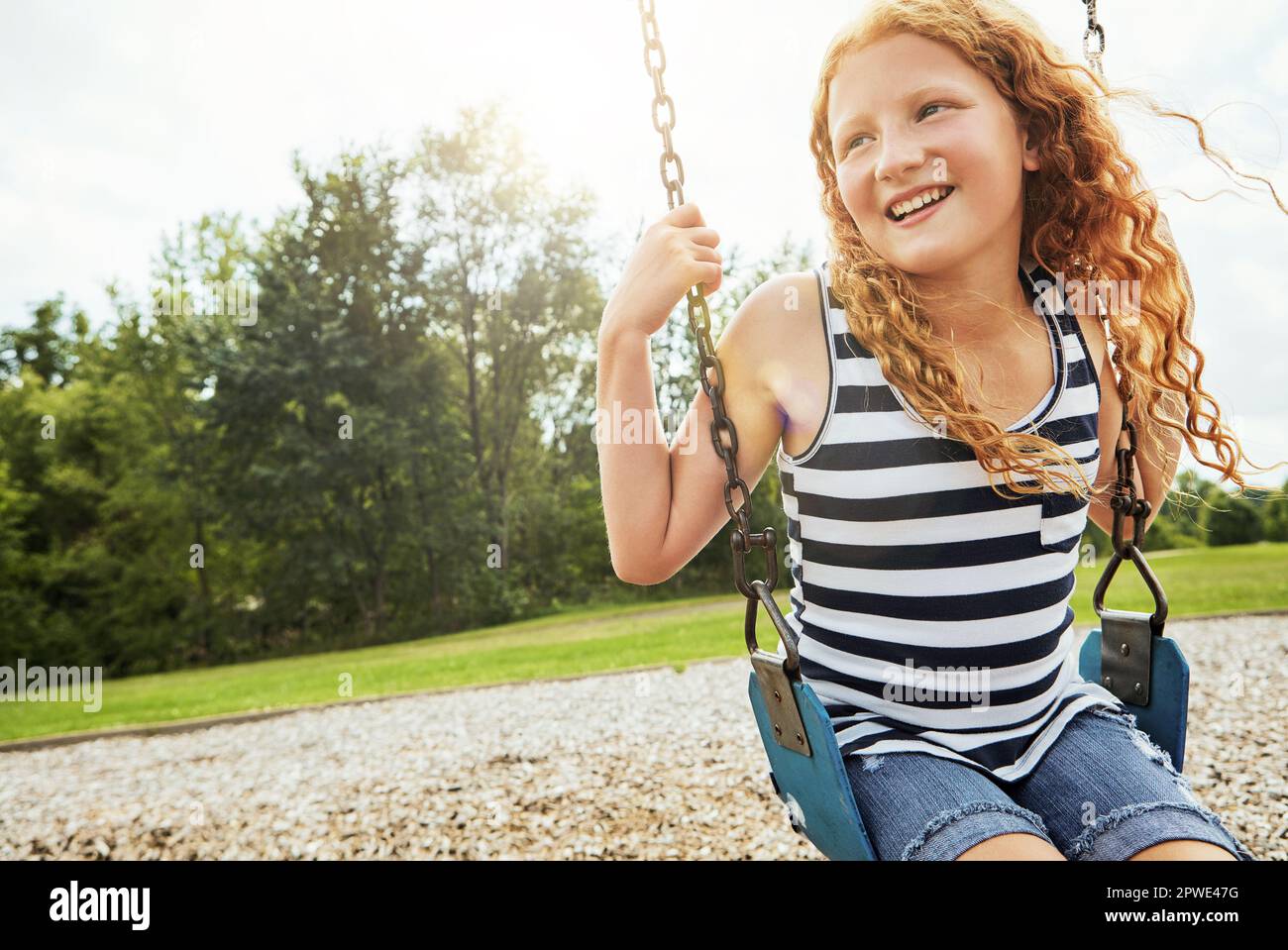 Childhood is bliss. a young girl playing on a swing at the park Stock Photo - Alamy