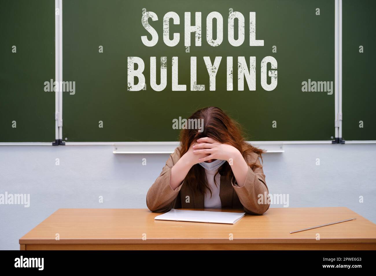 Text is a school bullying on the blackboard and a sad teacher in the ...