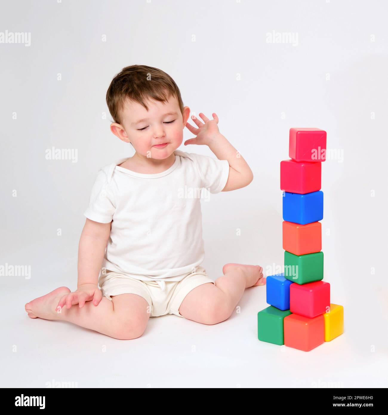 Happy baby play educational toys on studio white background. Portrait ...