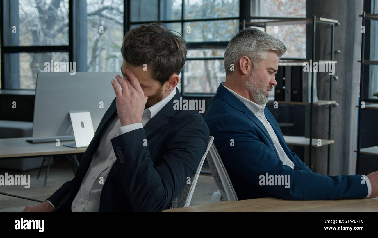 Upset shocked caucasian men businessmen partners employees sitting in ...