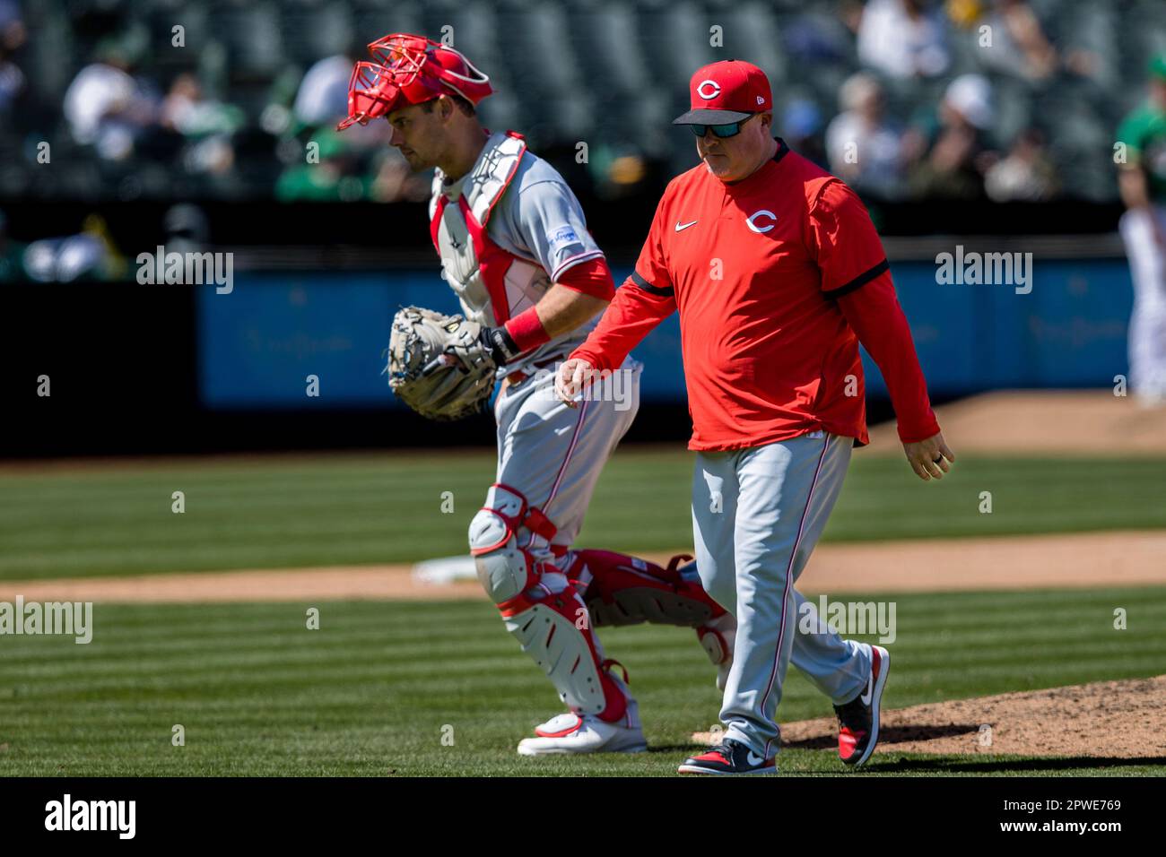 Cincinnati Reds catcher Luke Maile, left, walks with pitching coach ...