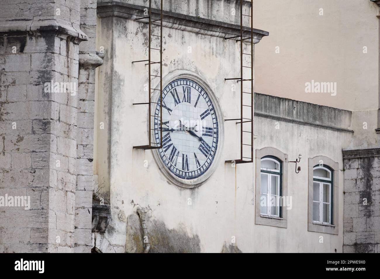 a wall-mounted clock in Lisbon Portugal Stock Photo - Alamy