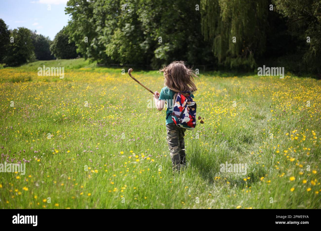 Child running through a wild meadow Stock Photo - Alamy