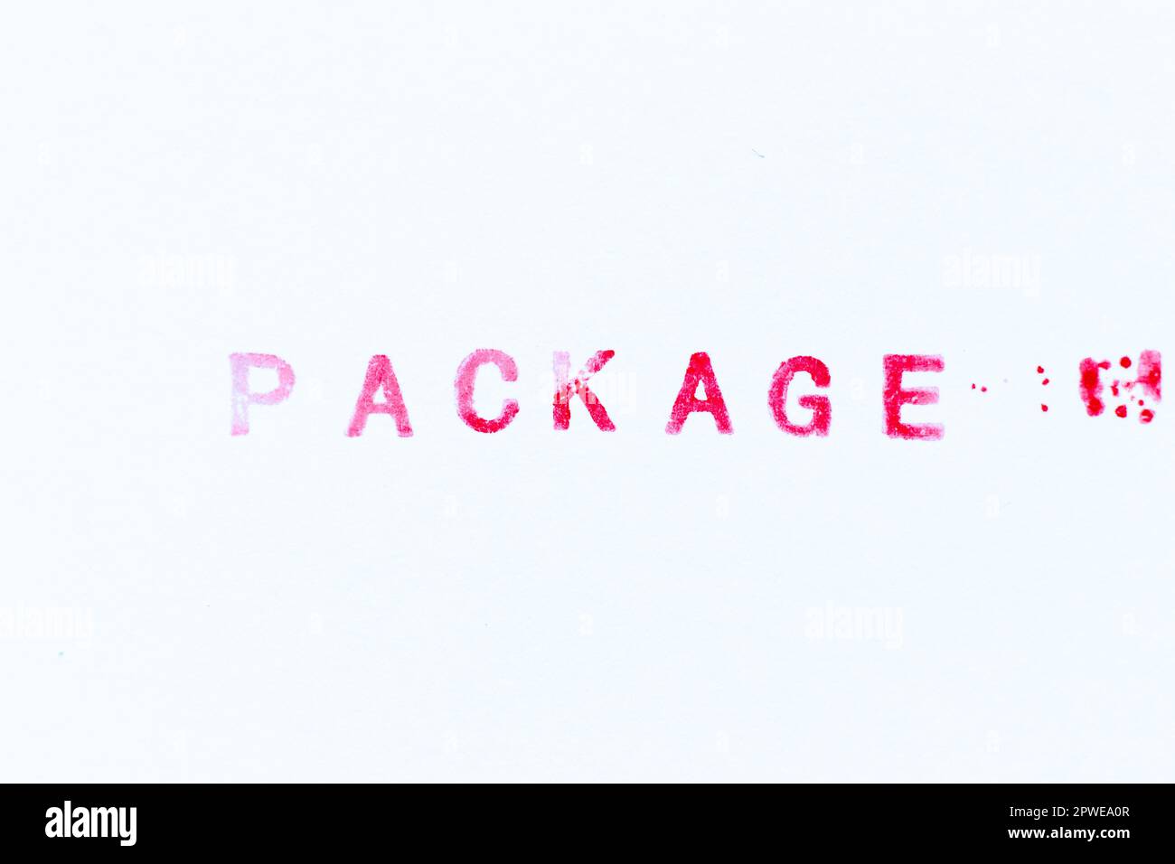 Red color ink rubber stamp in word package on white paper background ...