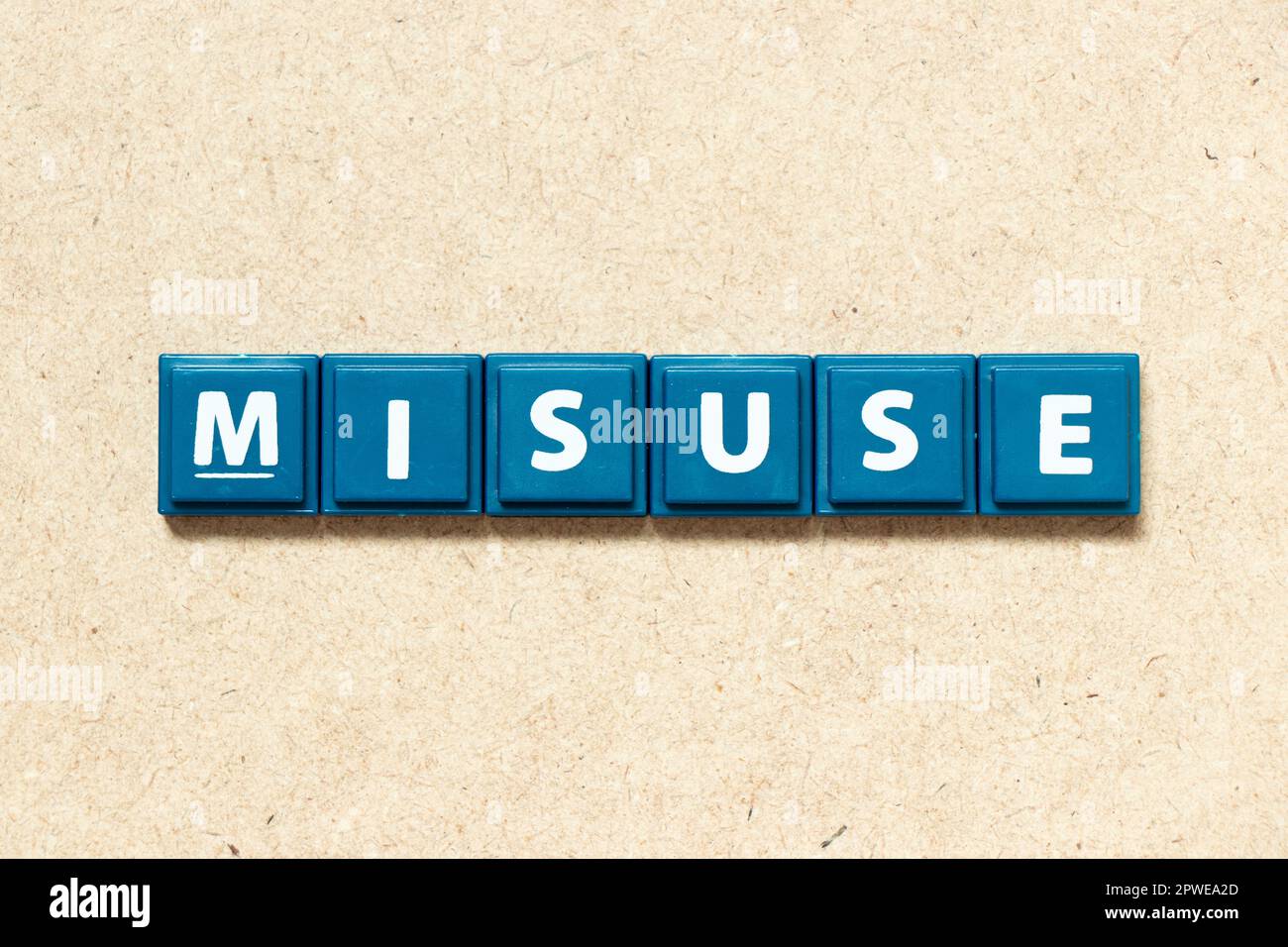 Tile alphabet letter in word misuse on wood background Stock Photo - Alamy