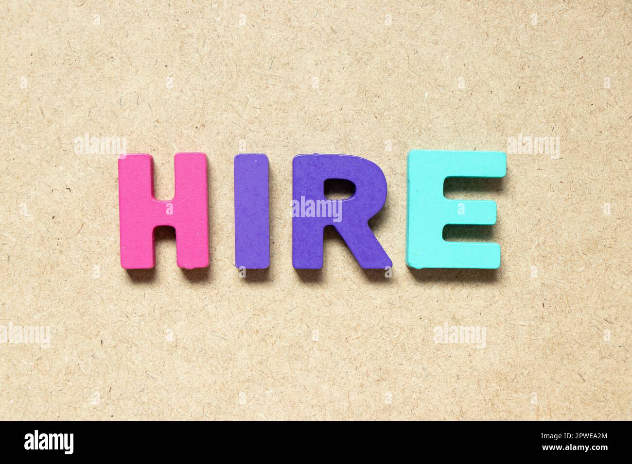 Color alphabet letter in word hire on wood background Stock Photo - Alamy