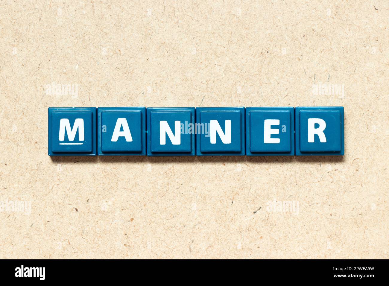 Tile alphabet letter in word manner on wood background Stock Photo - Alamy