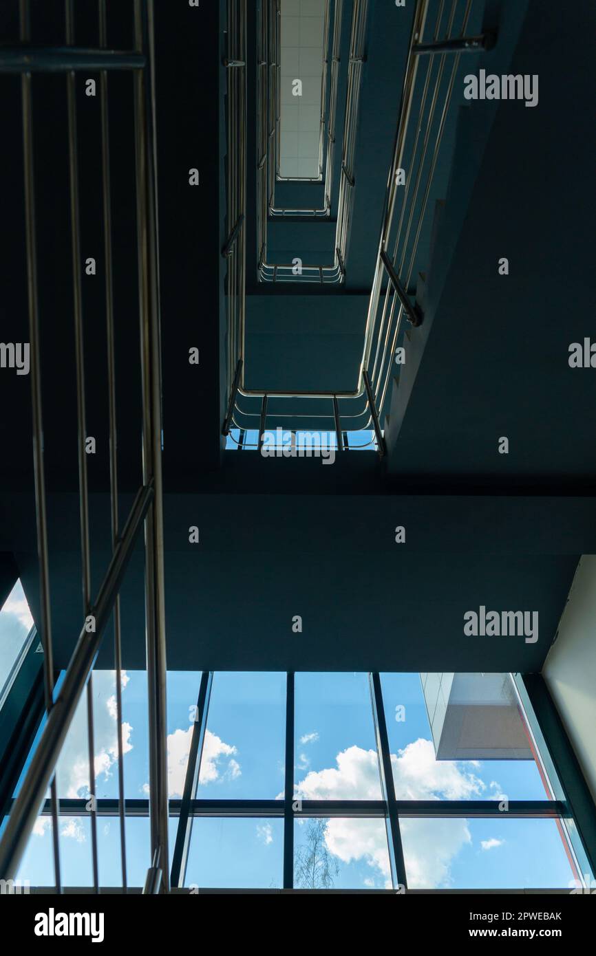 Stairs in a concrete office building in neutral tones, covered with ...