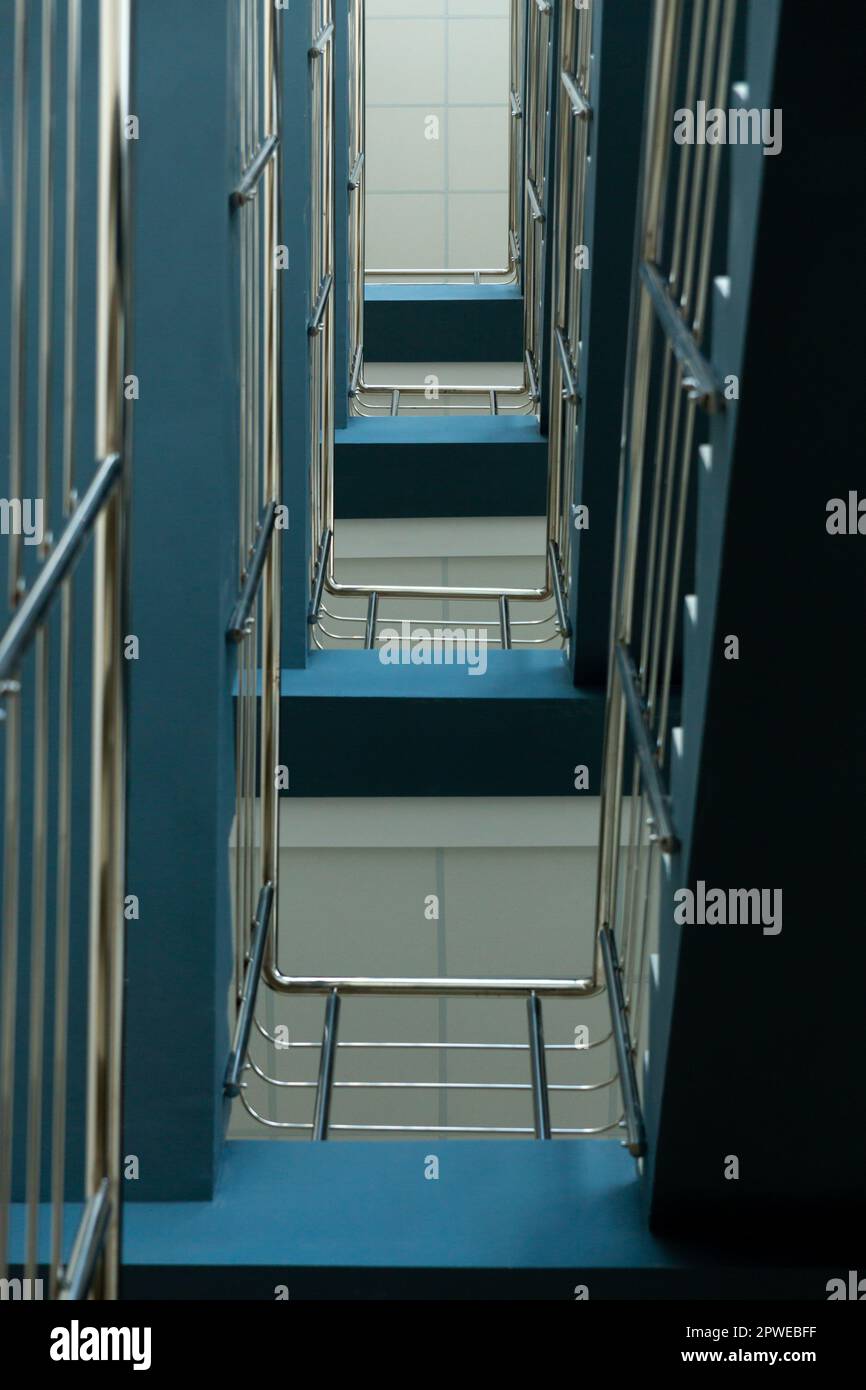 Stairs in a concrete office building in neutral tones, covered with ...