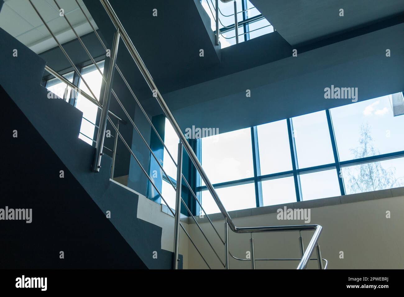 Stairs in a concrete office building in neutral tones, covered with ...