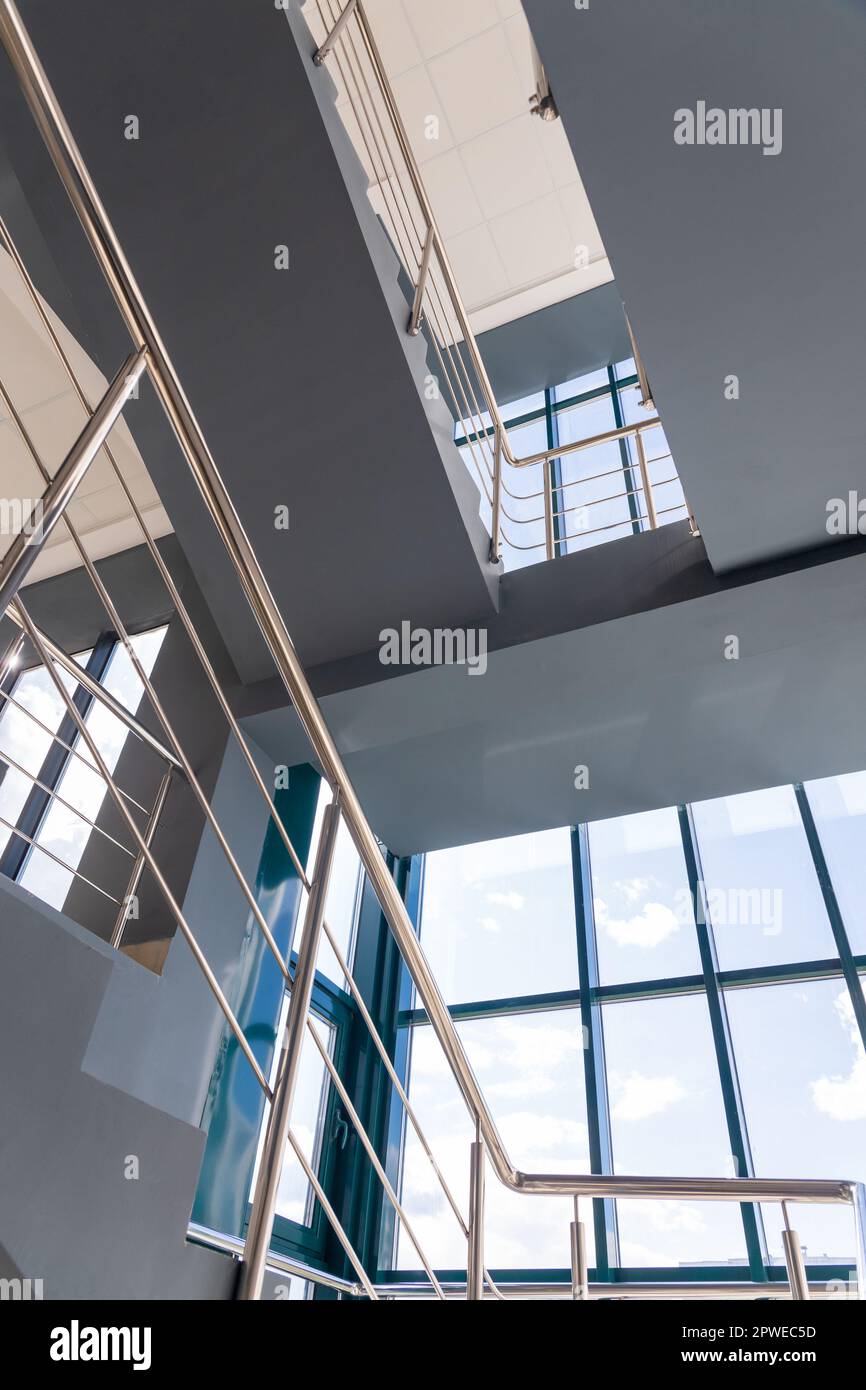 Stairs in a concrete office building in neutral tones, covered with ...