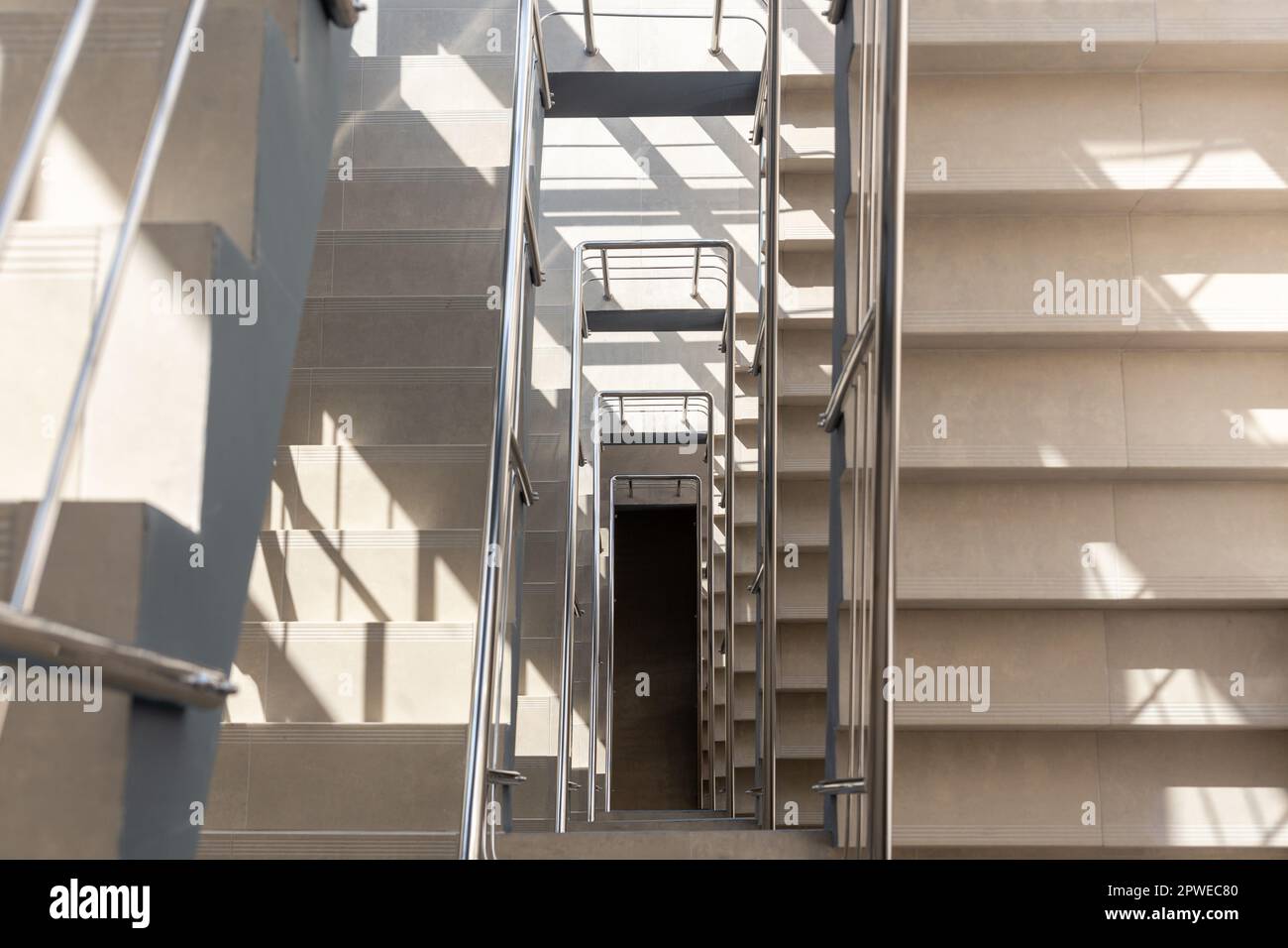 Stairs in a concrete office building in neutral tones, covered with ...