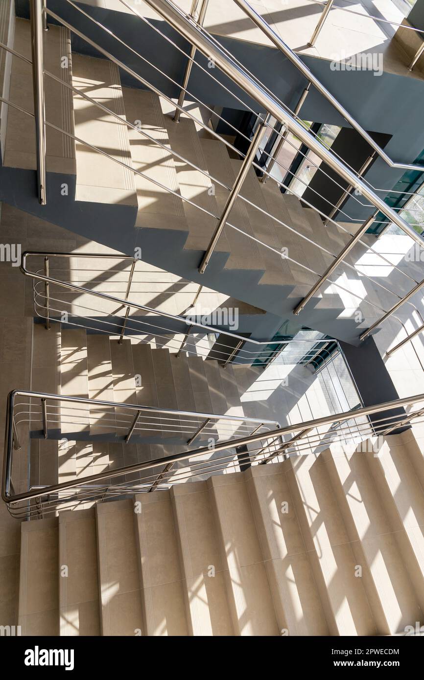 Stairs in a concrete office building in neutral tones, covered with ...