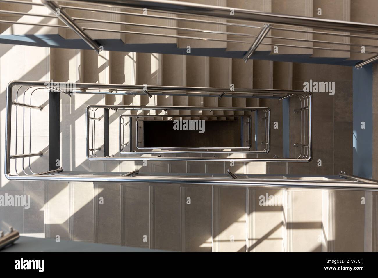 Stairs in a concrete office building in neutral tones, covered with ...