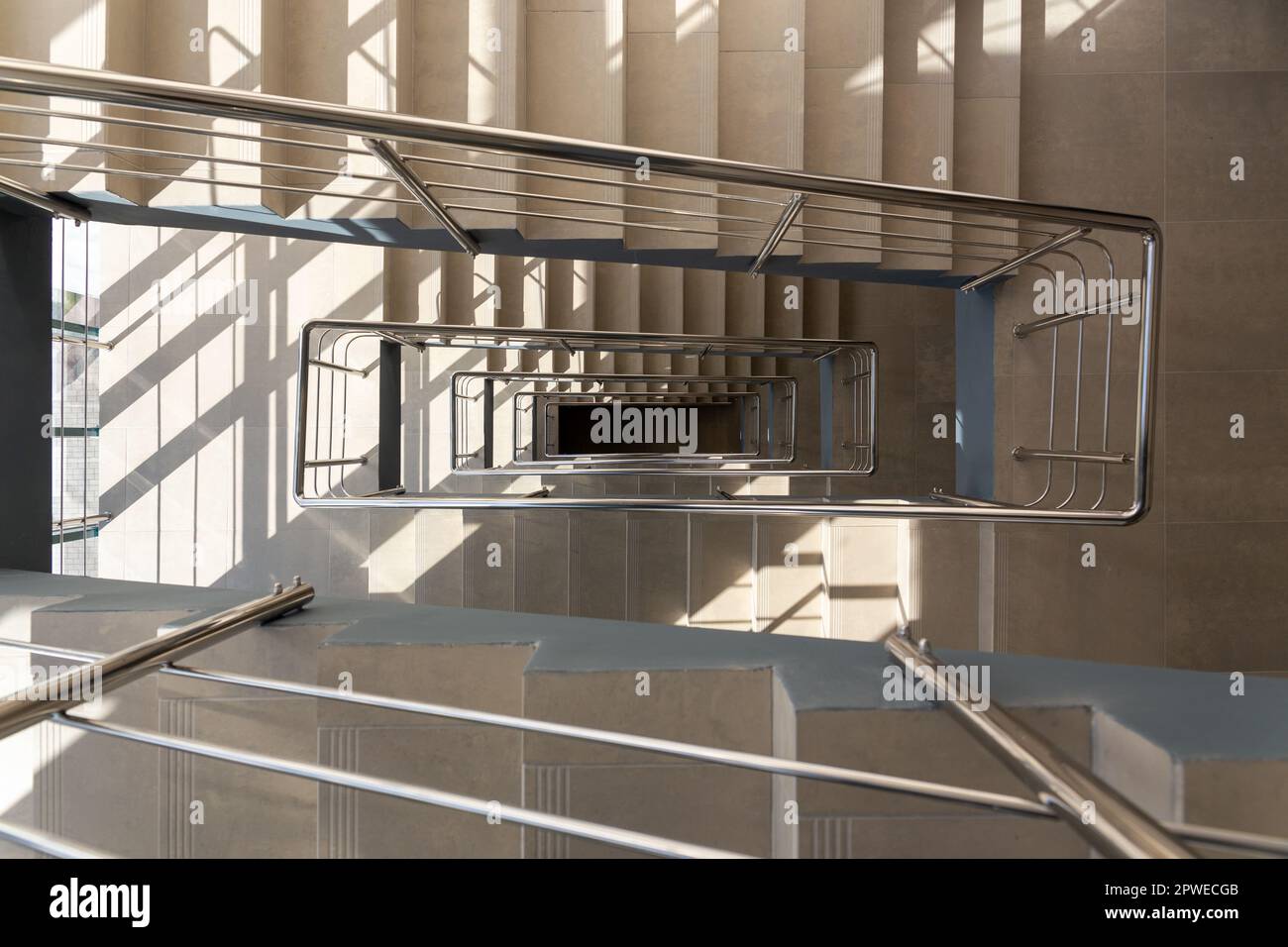 Stairs in a concrete office building in neutral tones, covered with ...
