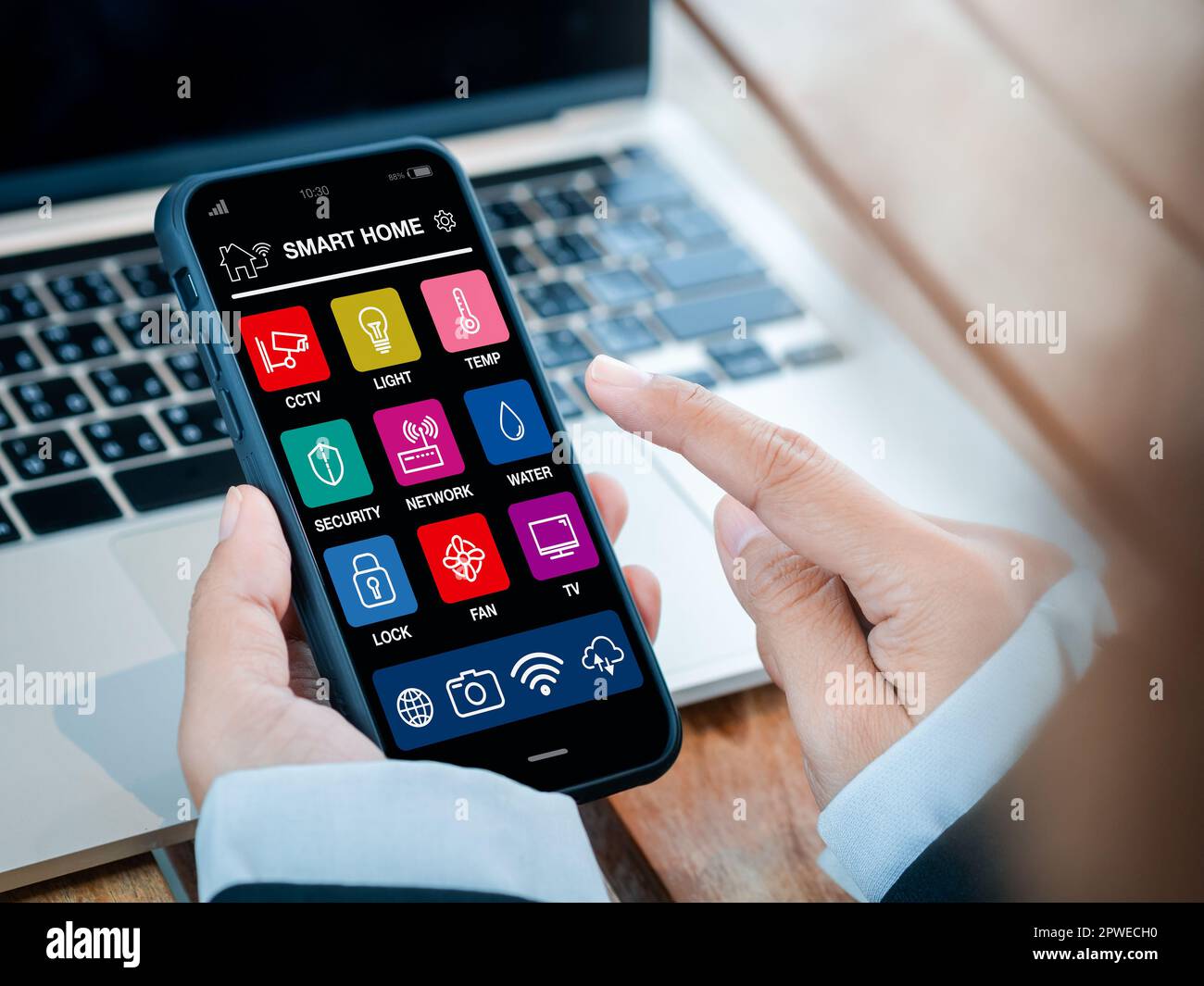 Smart home applications technology on smartphone holding in hand. Smart house app screen on ...