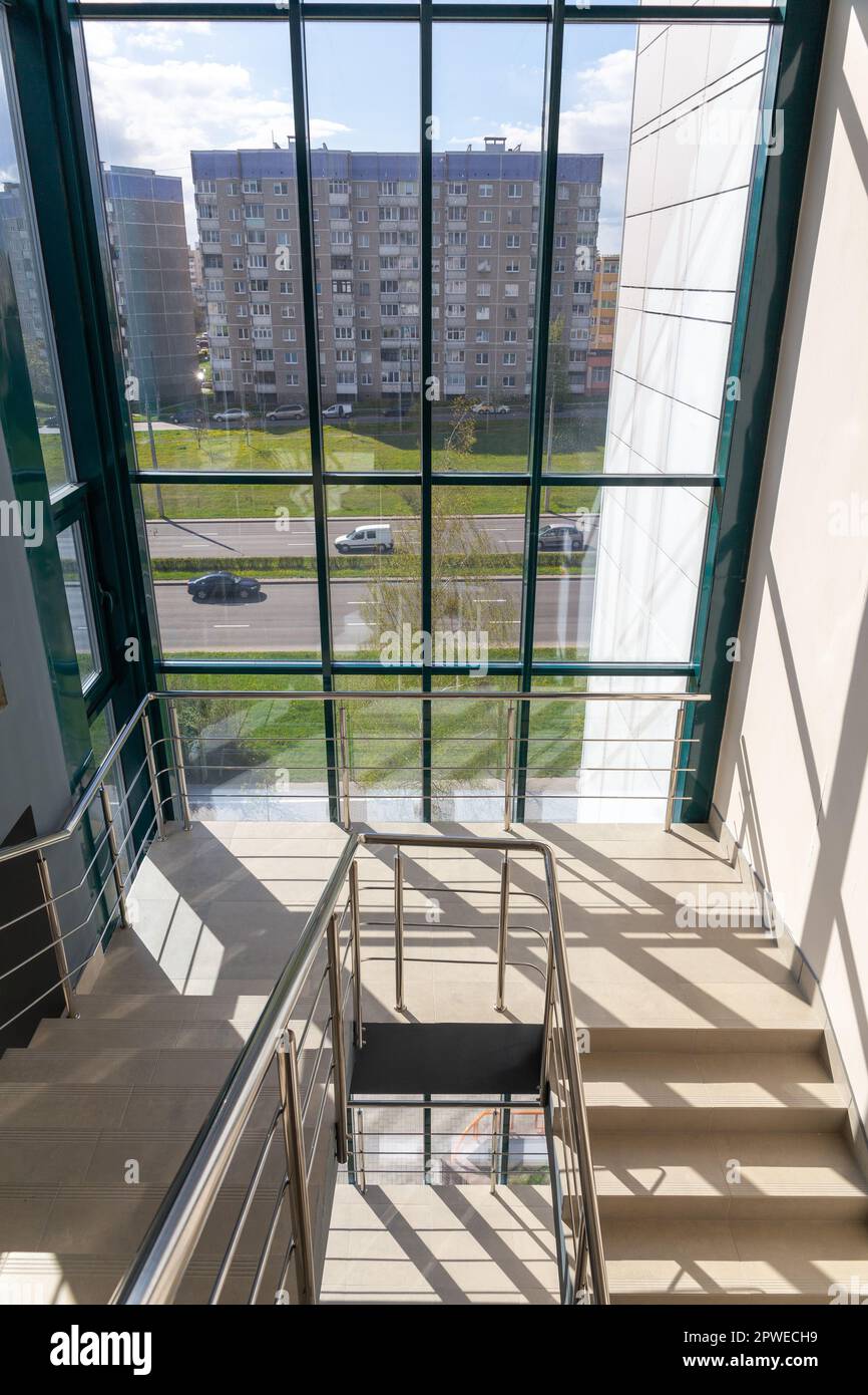 Stairs in a concrete office building in neutral tones, covered with ...