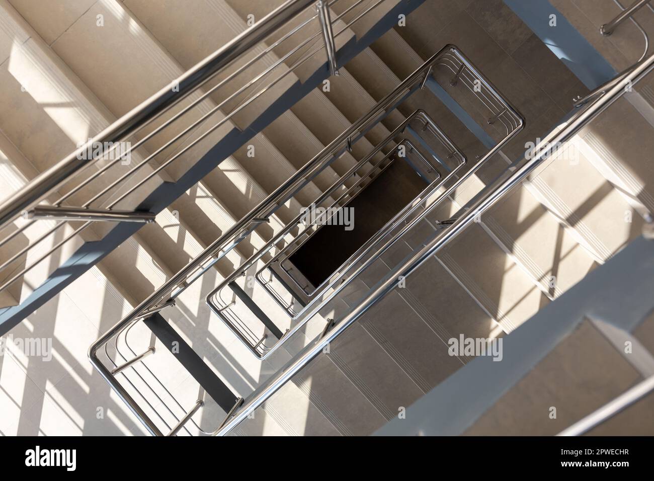 Stairs in a concrete office building in neutral tones, covered with ...