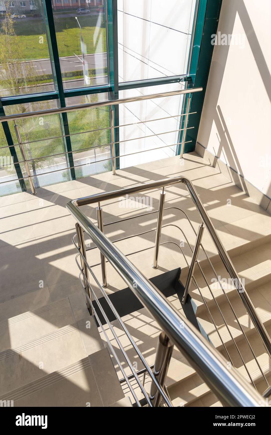 Stairs in a concrete office building in neutral tones, covered with ...