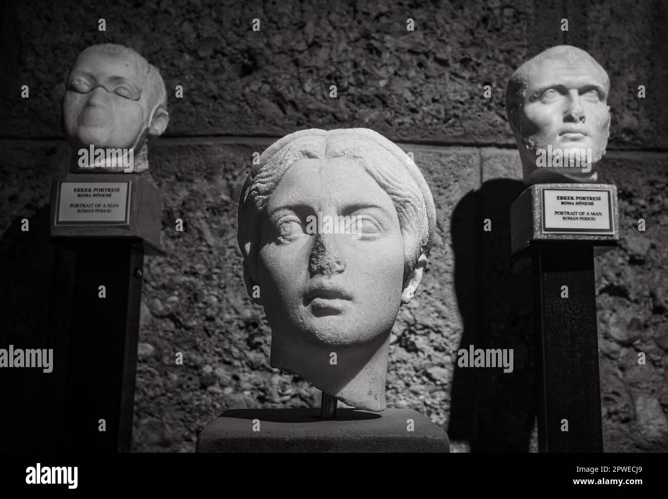 A 2nd Century AD carved marble head of a woman, flanked by two carved ...