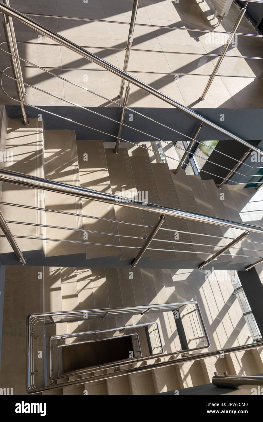 Stairs in a concrete office building in neutral tones, covered with ...