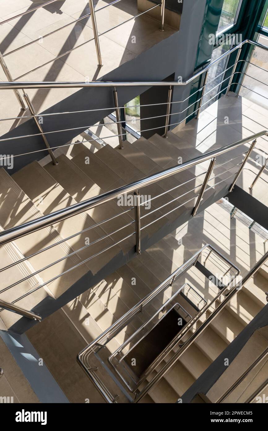 Stairs in a concrete office building in neutral tones, covered with ...