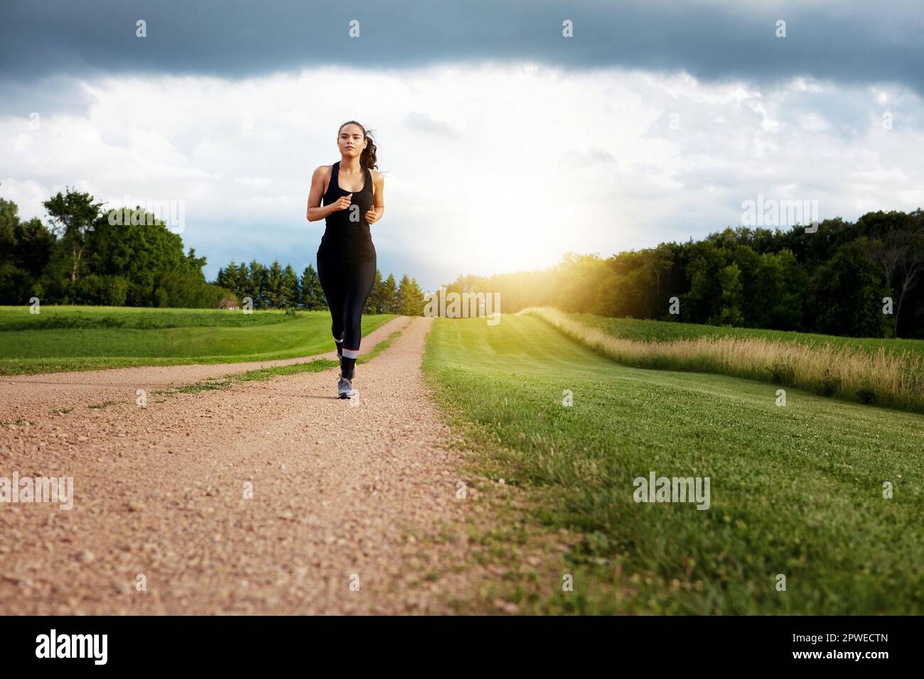 This princess wears running shoes. a fit young woman out for a run on a beautiful day Stock ...