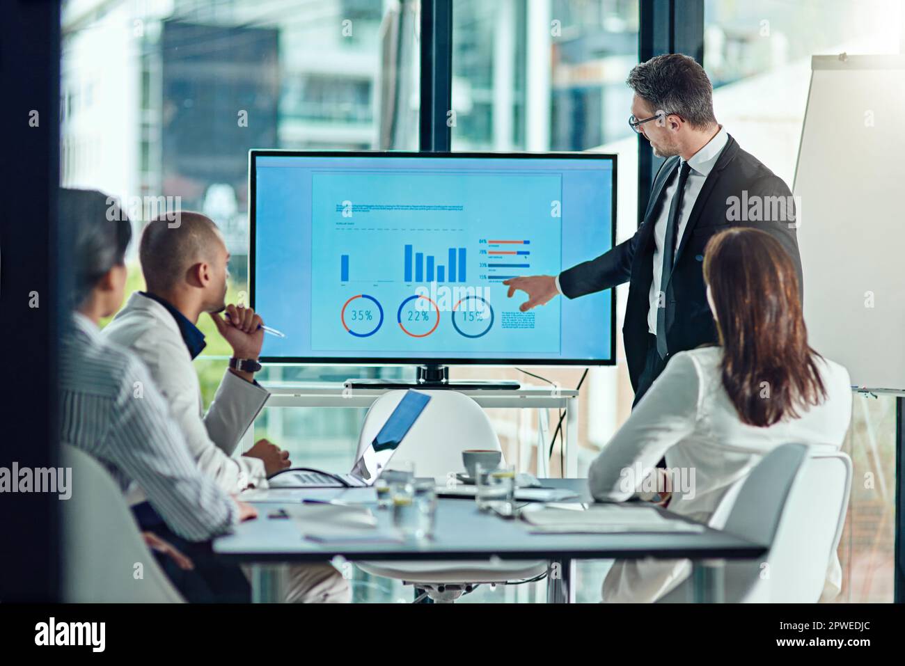 Using a visual method to get his point across. a businessman delivering ...