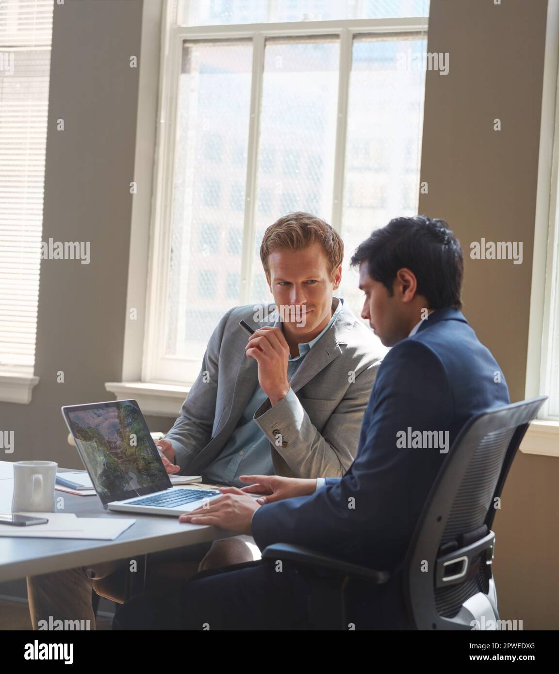 Going over the details. businessmen working in their office Stock Photo ...