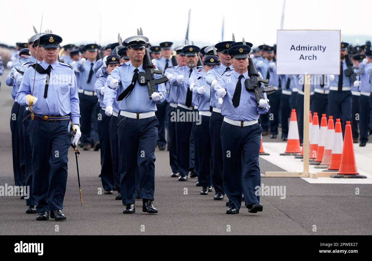 Members of the Royal Air Force march along the runway at RAF Odiham ...