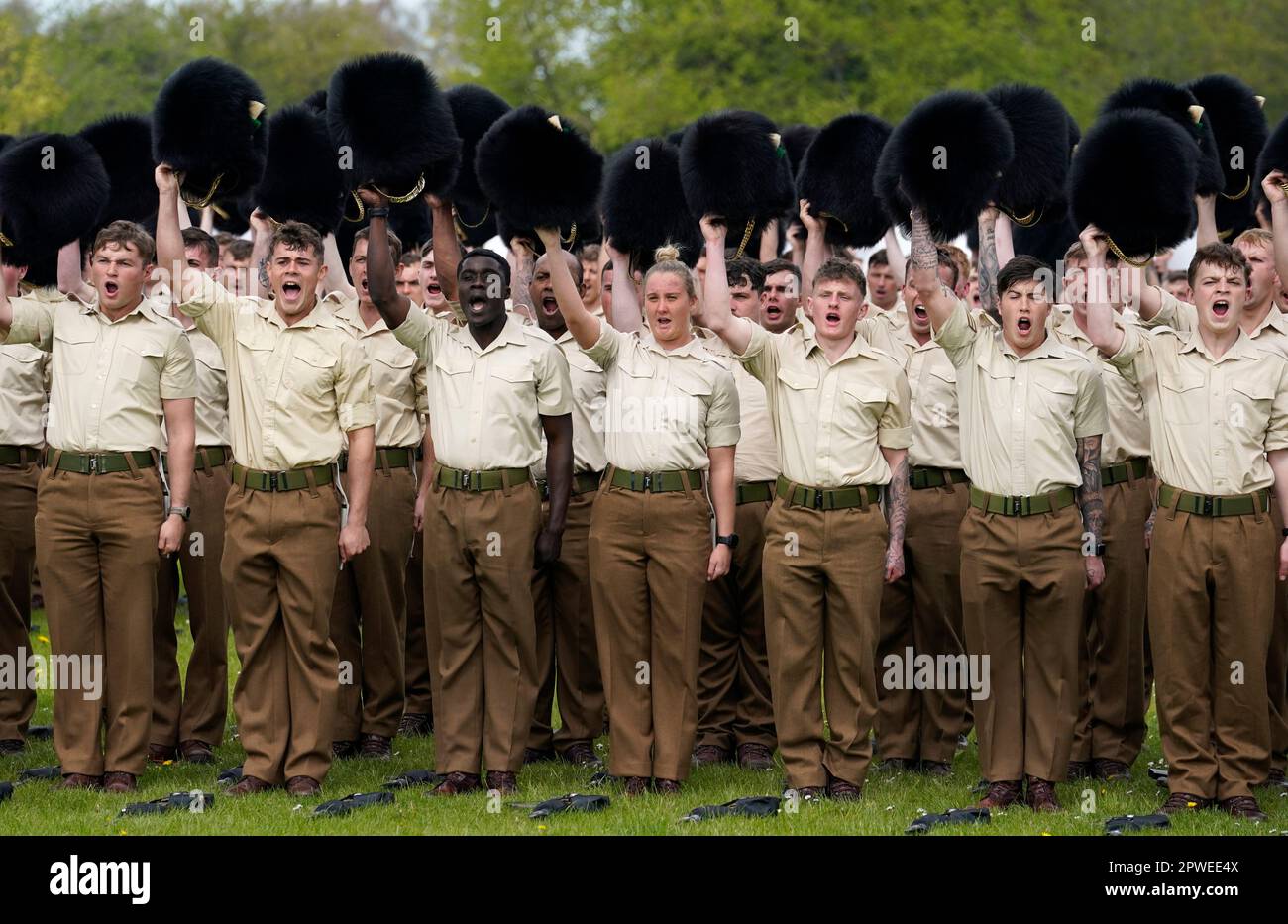 Members of the Welsh Guards remove their head dress as they give three ...