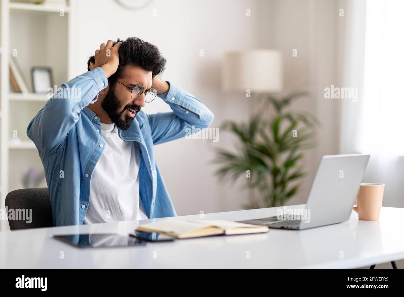 Deadline Stress. Shocked indian man looking at laptop screen and ...