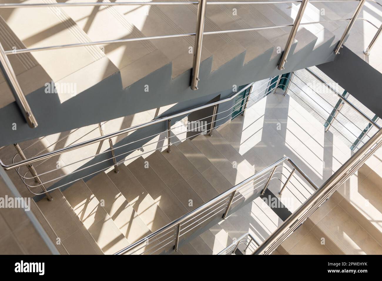 Stairs in a concrete office building in neutral tones, covered with ...