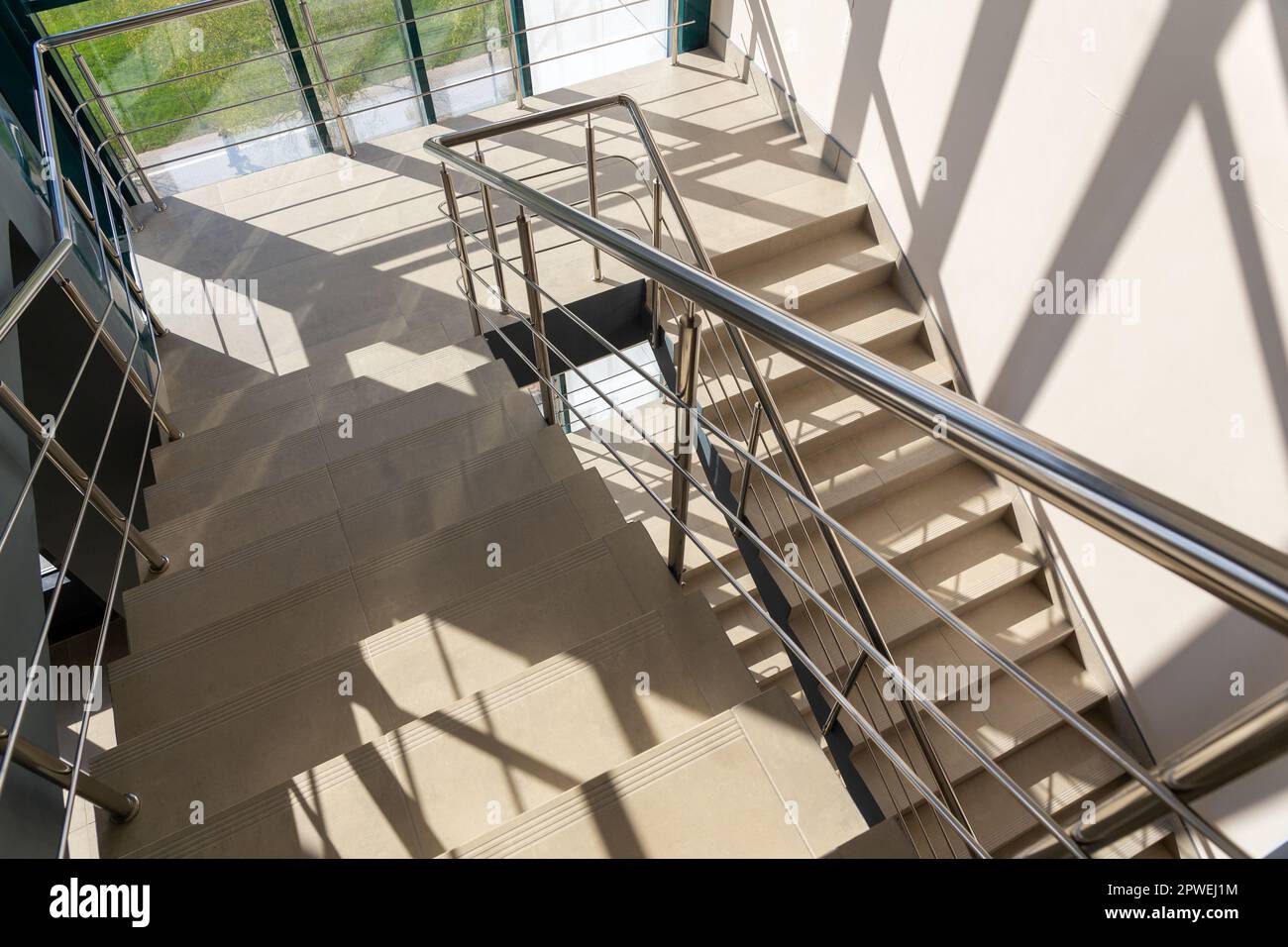 Stairs in a concrete office building in neutral tones, covered with ...