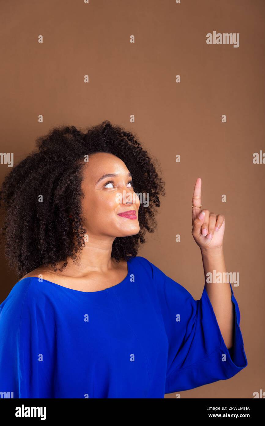 Beautiful young business woman making hand gestures. Standing against a ...