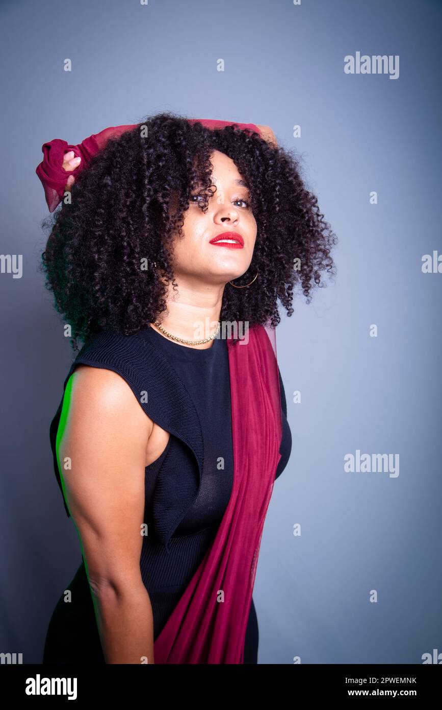 Beautiful woman in red cloth and black dress isolated on gray ...