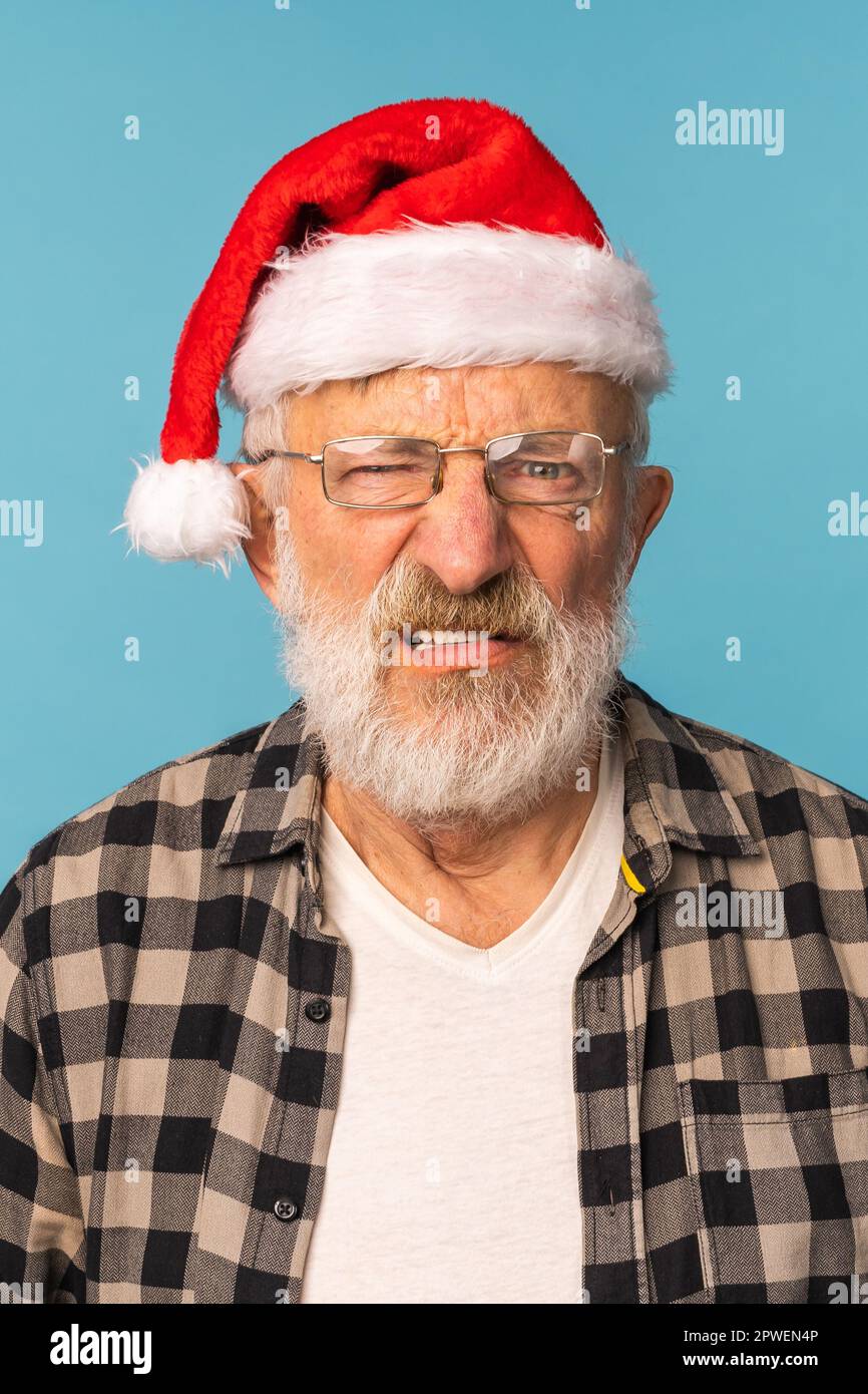 Gloomy angry Santa Claus portrait against blue background. Economy ...